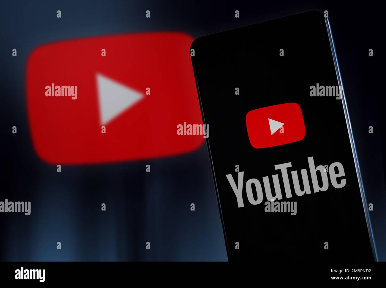YouTube logo on smartphone display and background. Video streaming ...