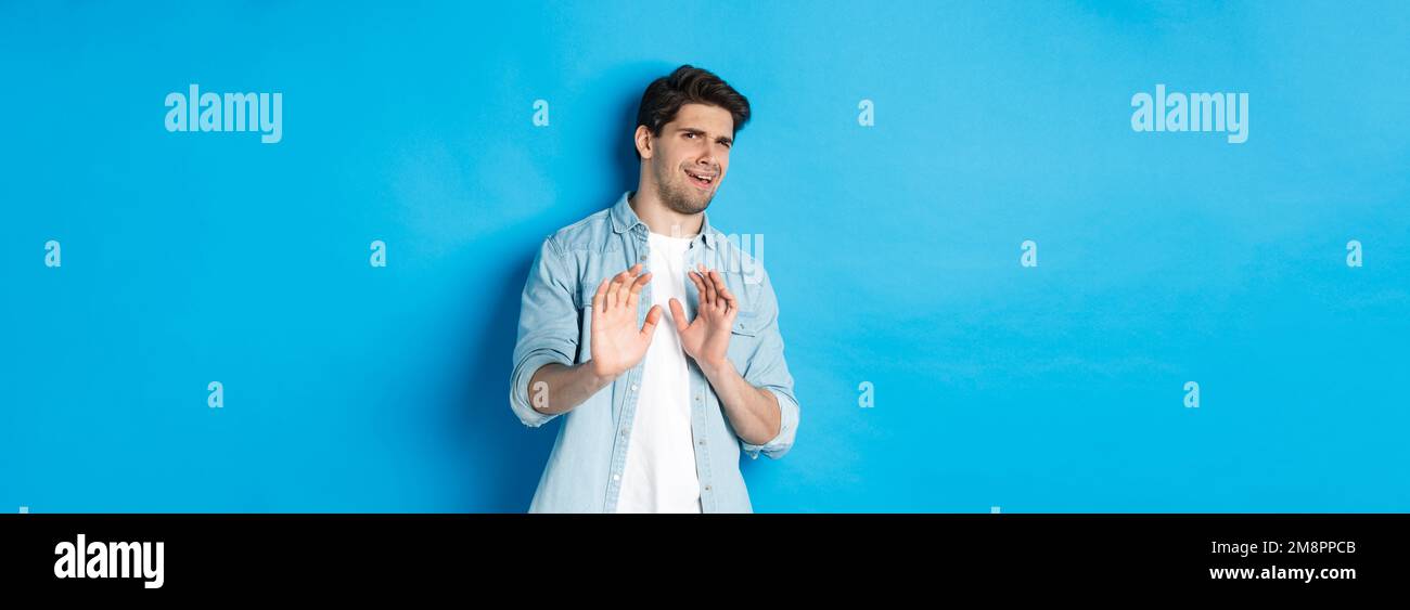 Displeased man refusing, saying no and cringe from something disgusting ...