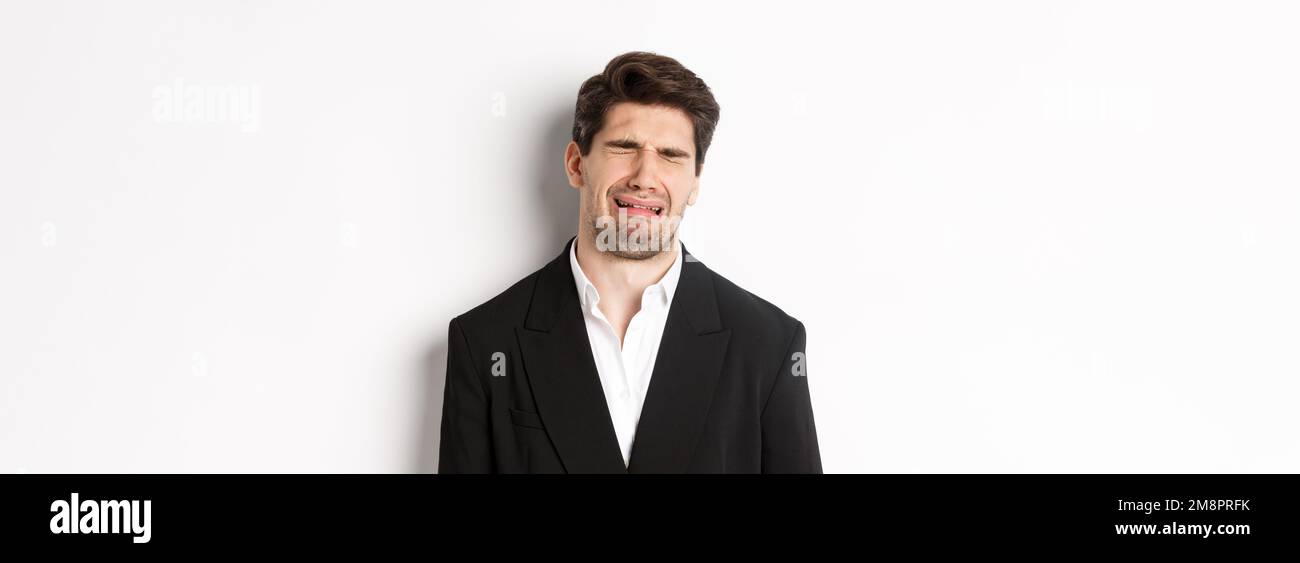 Close-up of miserable man in suit, crying and sobbing, feeling sad ...