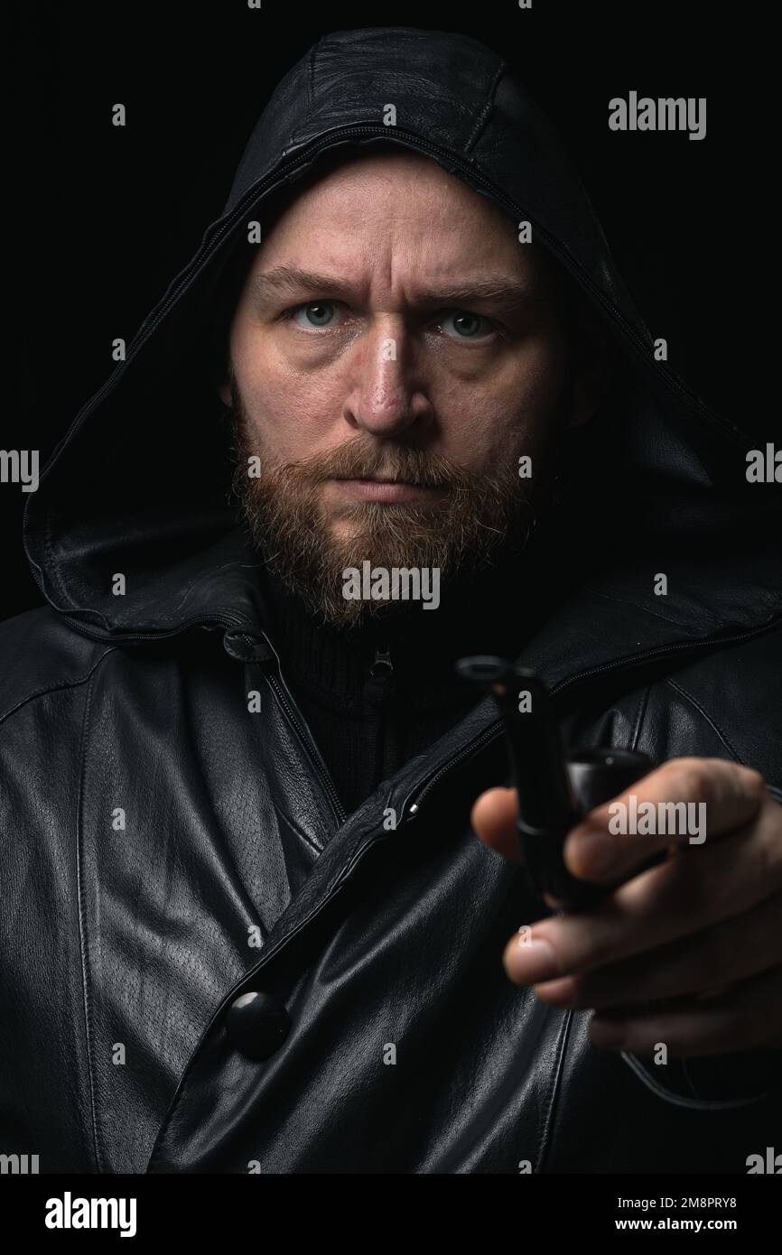 Portrait of a Bearded man in Black Rain Jacket Smoking a Pipe Stock ...