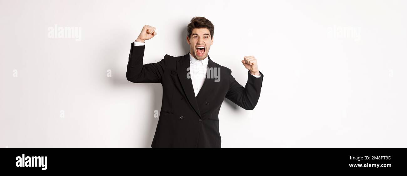 Portrait of successful businessman in black suit, become champion ...