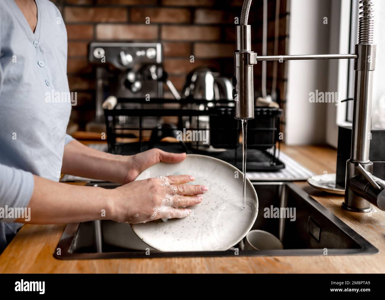 Girl washing dishes at kitchen at home Stock Photo - Alamy