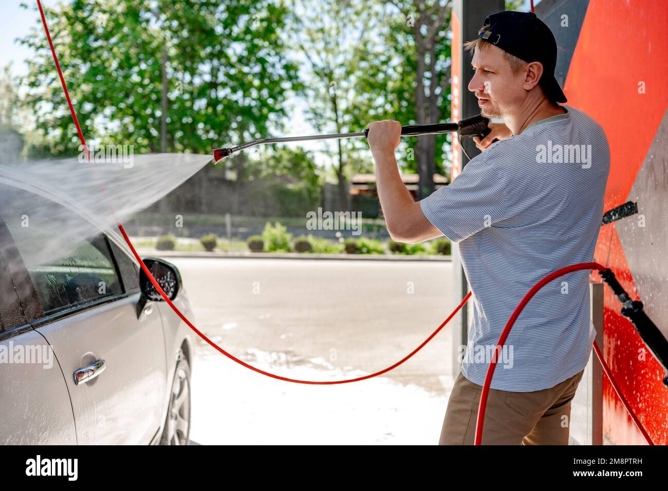 Shot of a man washing his car Stock Photo - Alamy