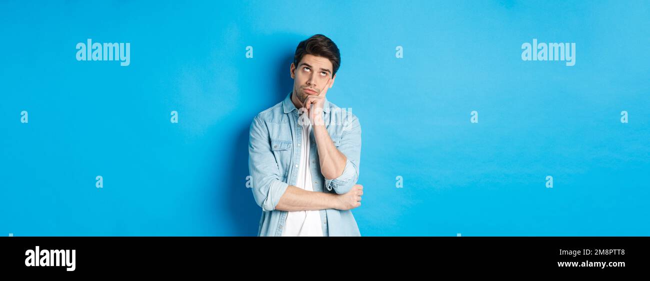 Annoyed adult man rolling eyes and looking bored, standing indifferent ...