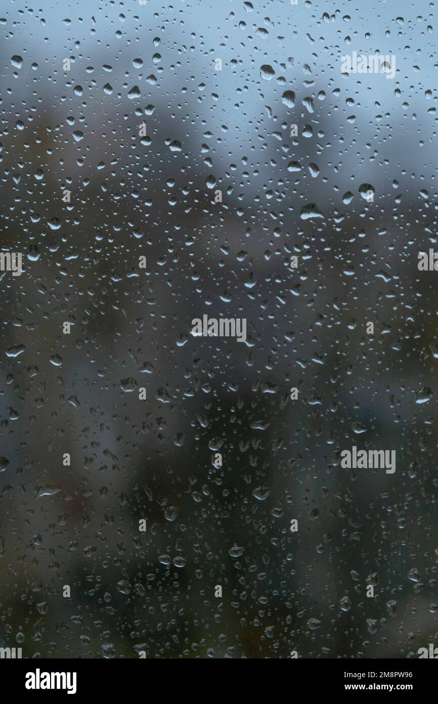 Fall rain. Textured surface of raindrops on window glass on blurred ...