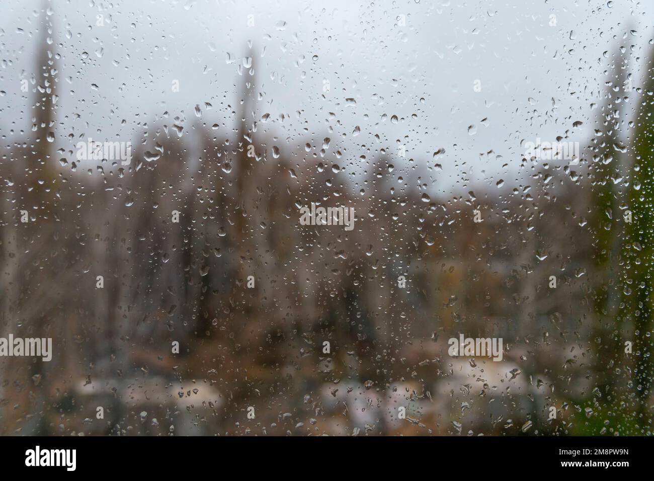Fall rain. Textured surface of raindrops on window pane against ...