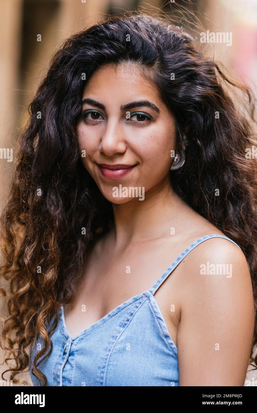 vertical portrait of an attractive turkish woman dressing denim dress ...