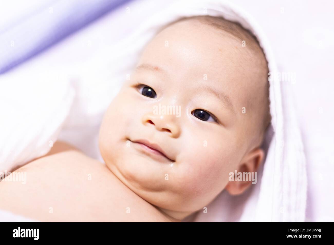 Wrapped in a towel boys Stock Photo - Alamy