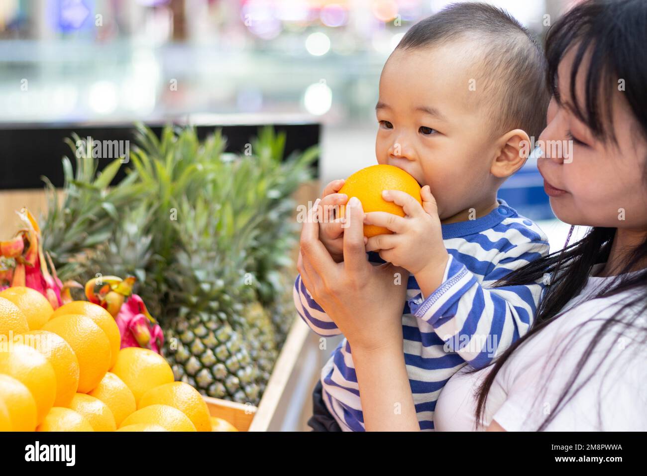 Mother and son two people pick fruit Stock Photo - Alamy