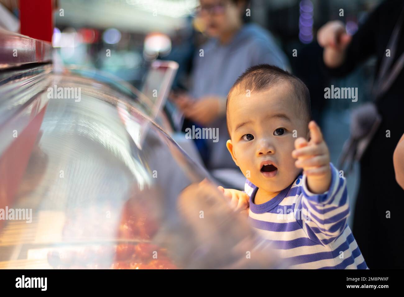 The little boy standing beside the window Stock Photo - Alamy