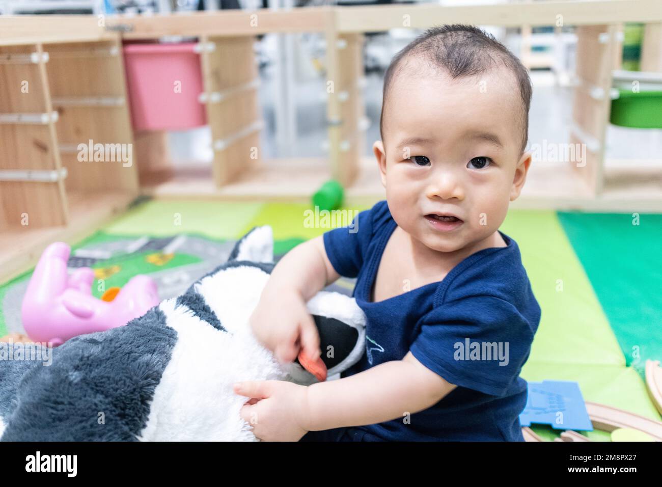 Happy baby and plush toys Stock Photo - Alamy