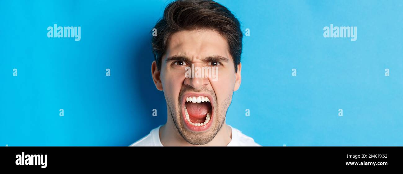 Head shot of angry man shouting and looking with hatred, standing mad ...