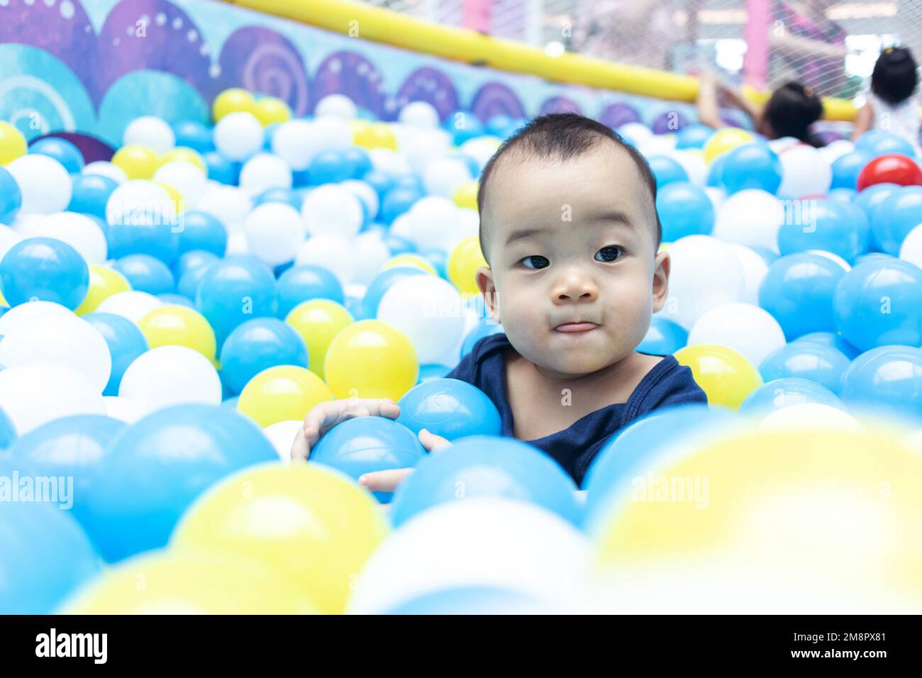Baby happy playing in the ocean ball Stock Photo - Alamy