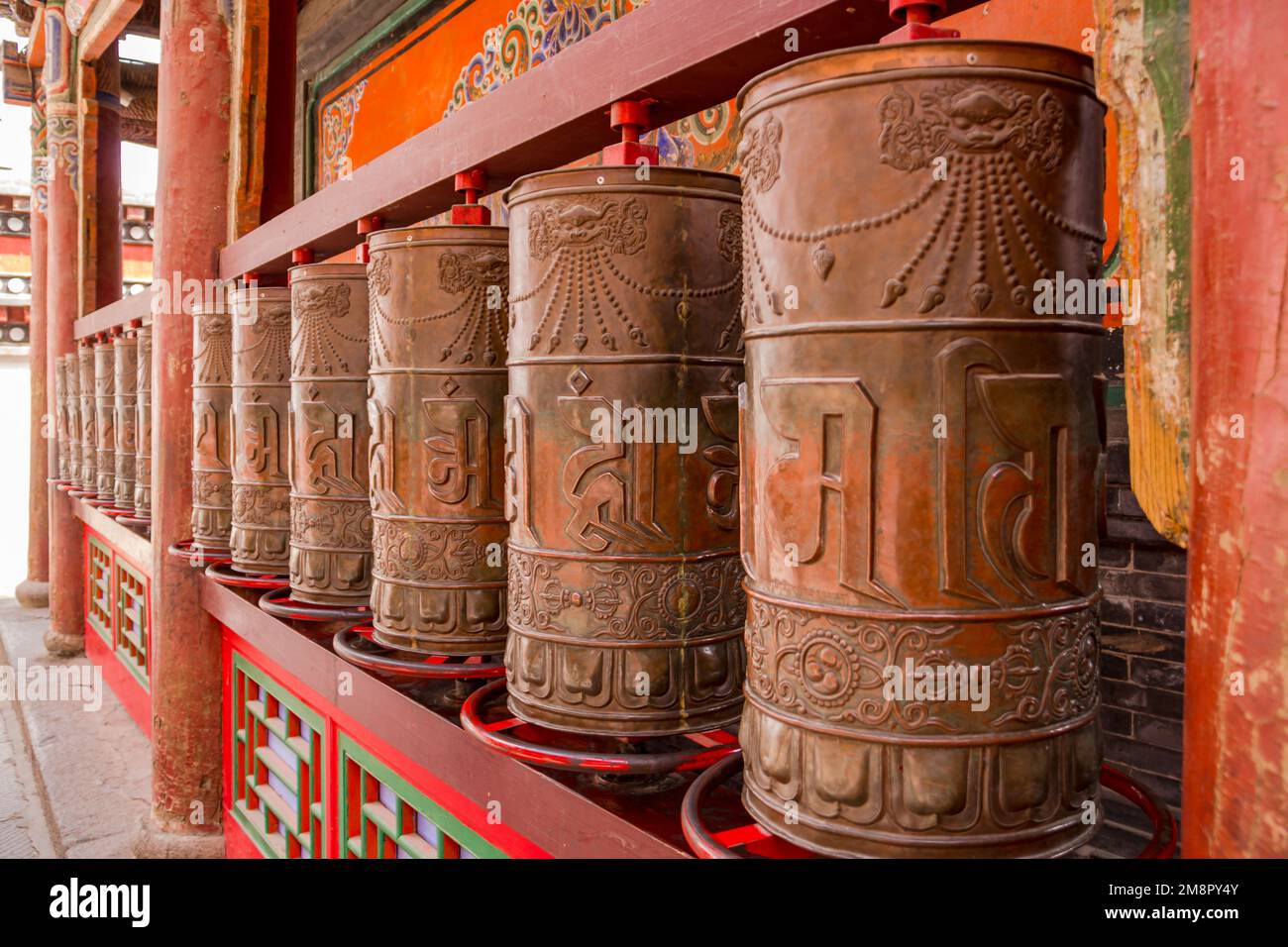 Large permanently installed prayer wheels in a temple of the Kumbum ...