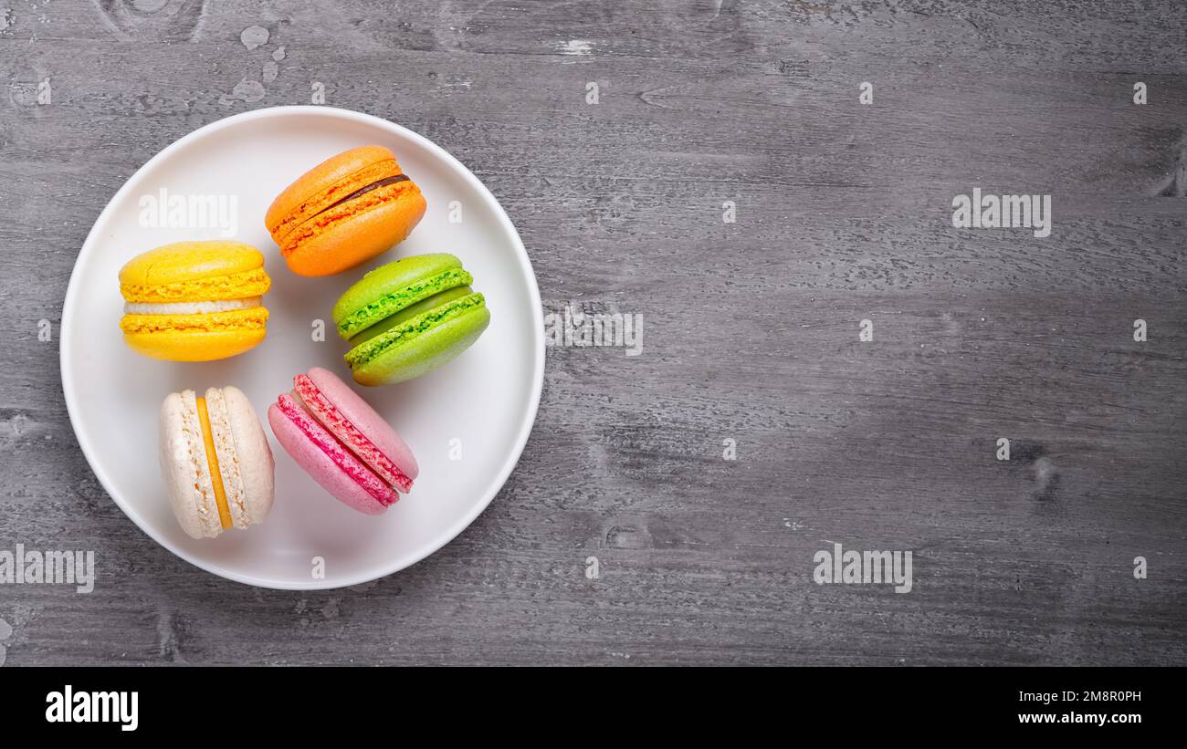 Sweet macarons on gray background Stock Photo - Alamy