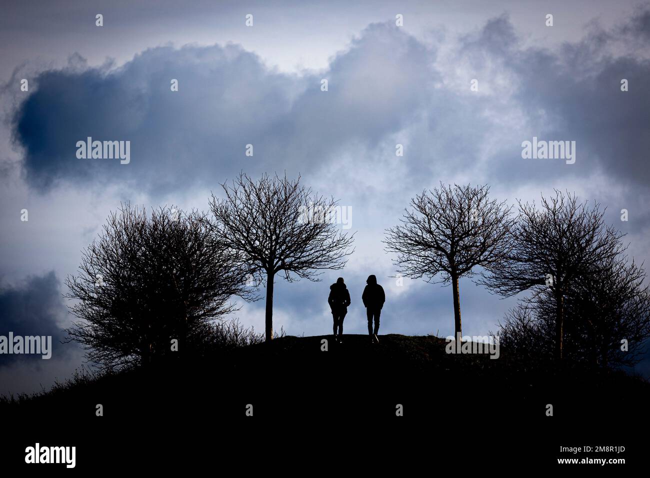 Hanover, Germany. 15th Jan, 2023. Walkers go up a hill at Kronsberg ...