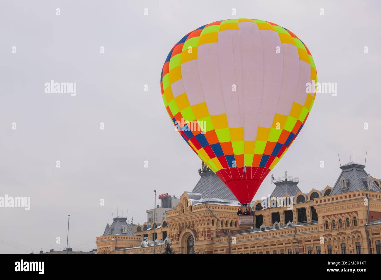 Colorful hot air balloon rising up against historical building Stock ...