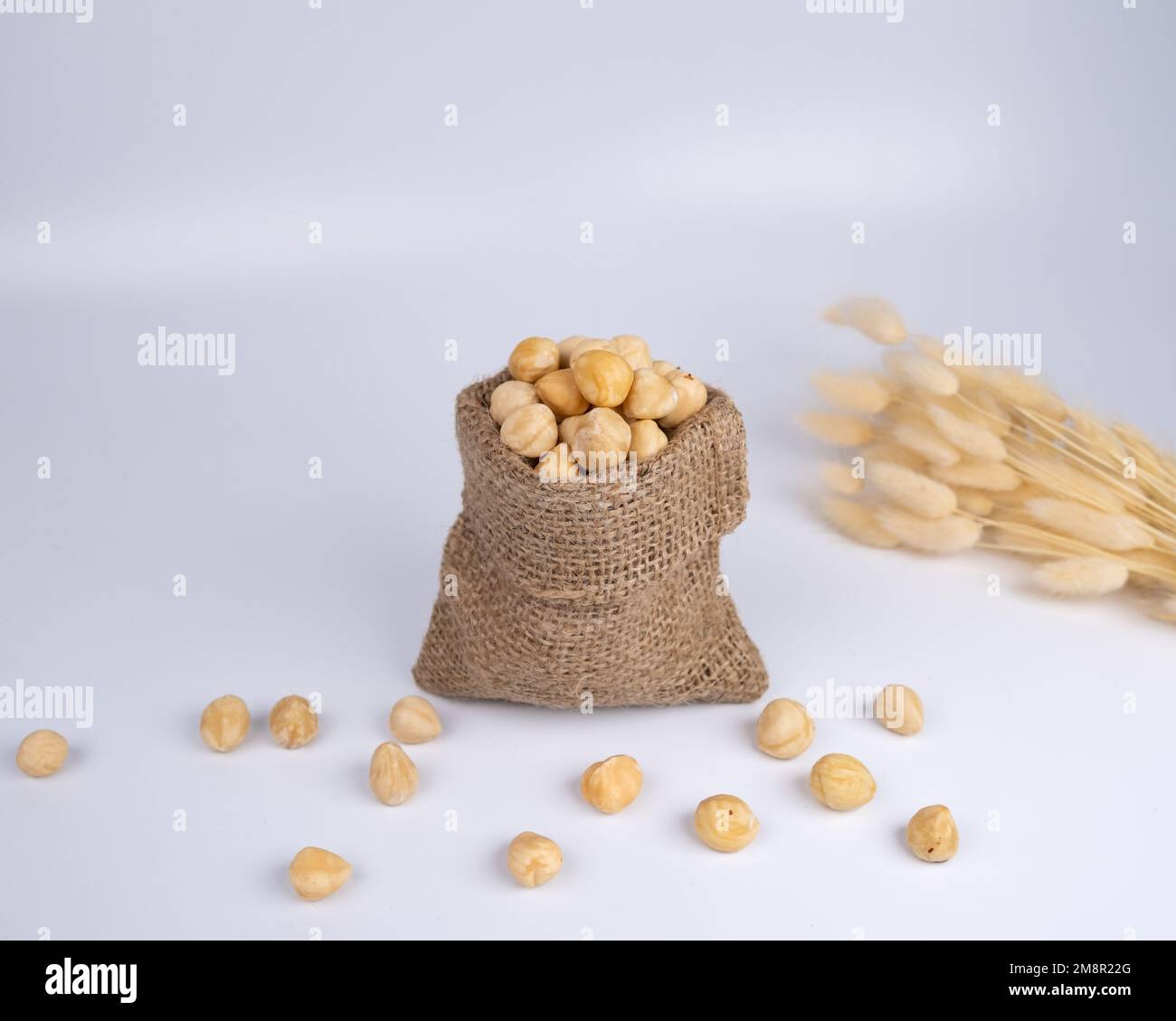 Nuts In A Fabric Sack On A White Background Stock Photo - Alamy