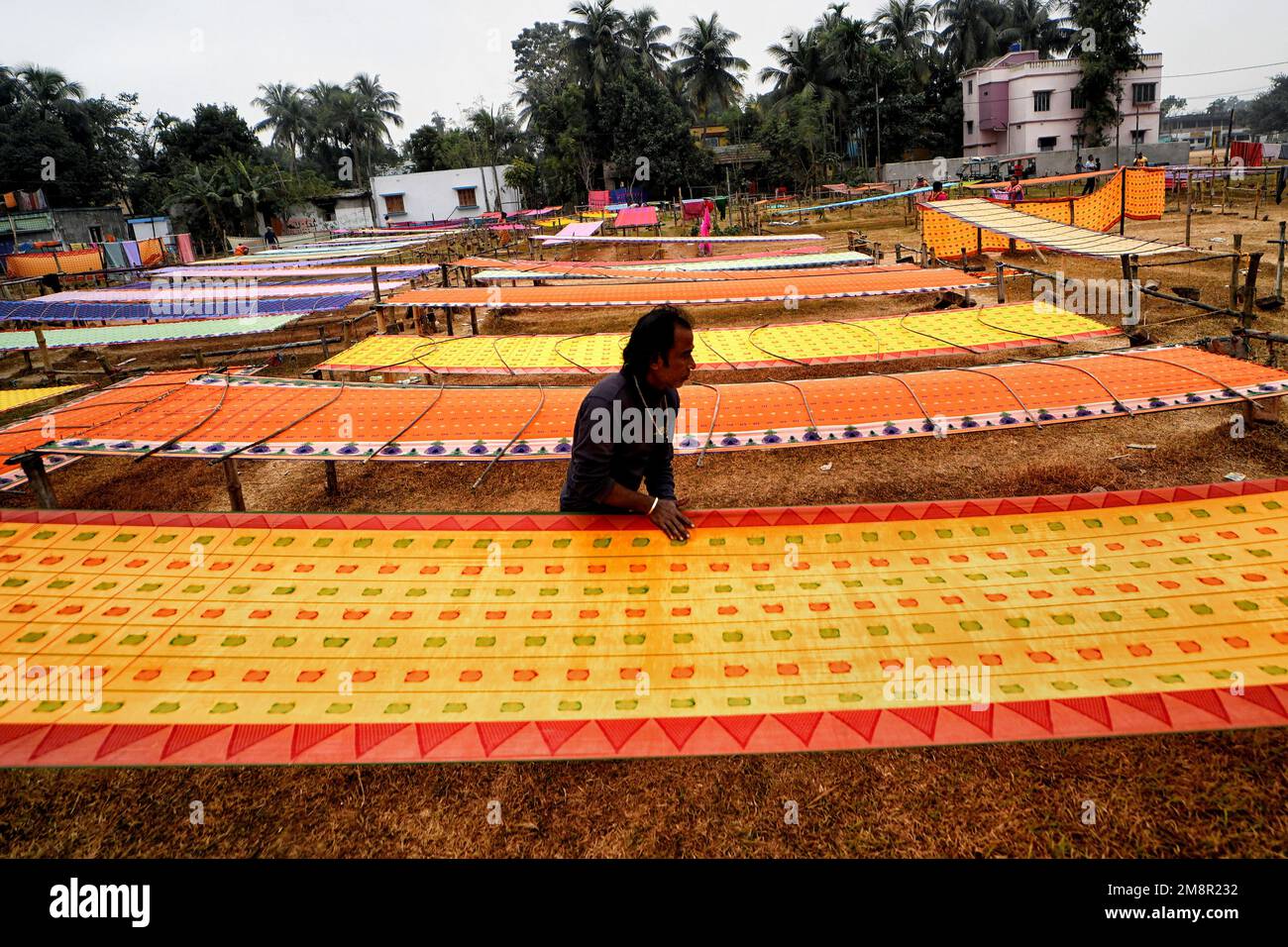 A weaver seen polishing the threads and checking the final designs of ...
