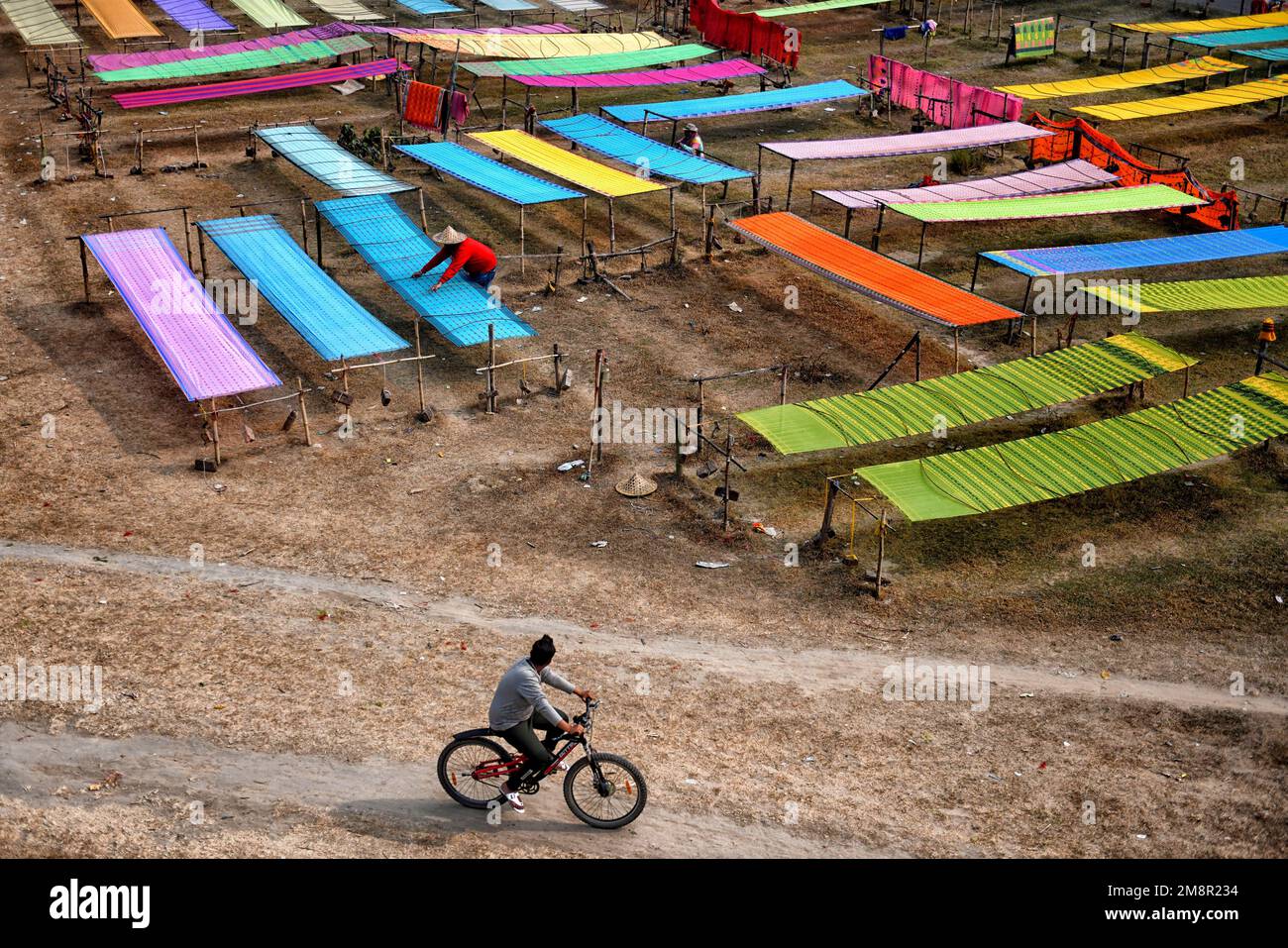 A view of colourful Indian sarees drying under sun. The traditional ...