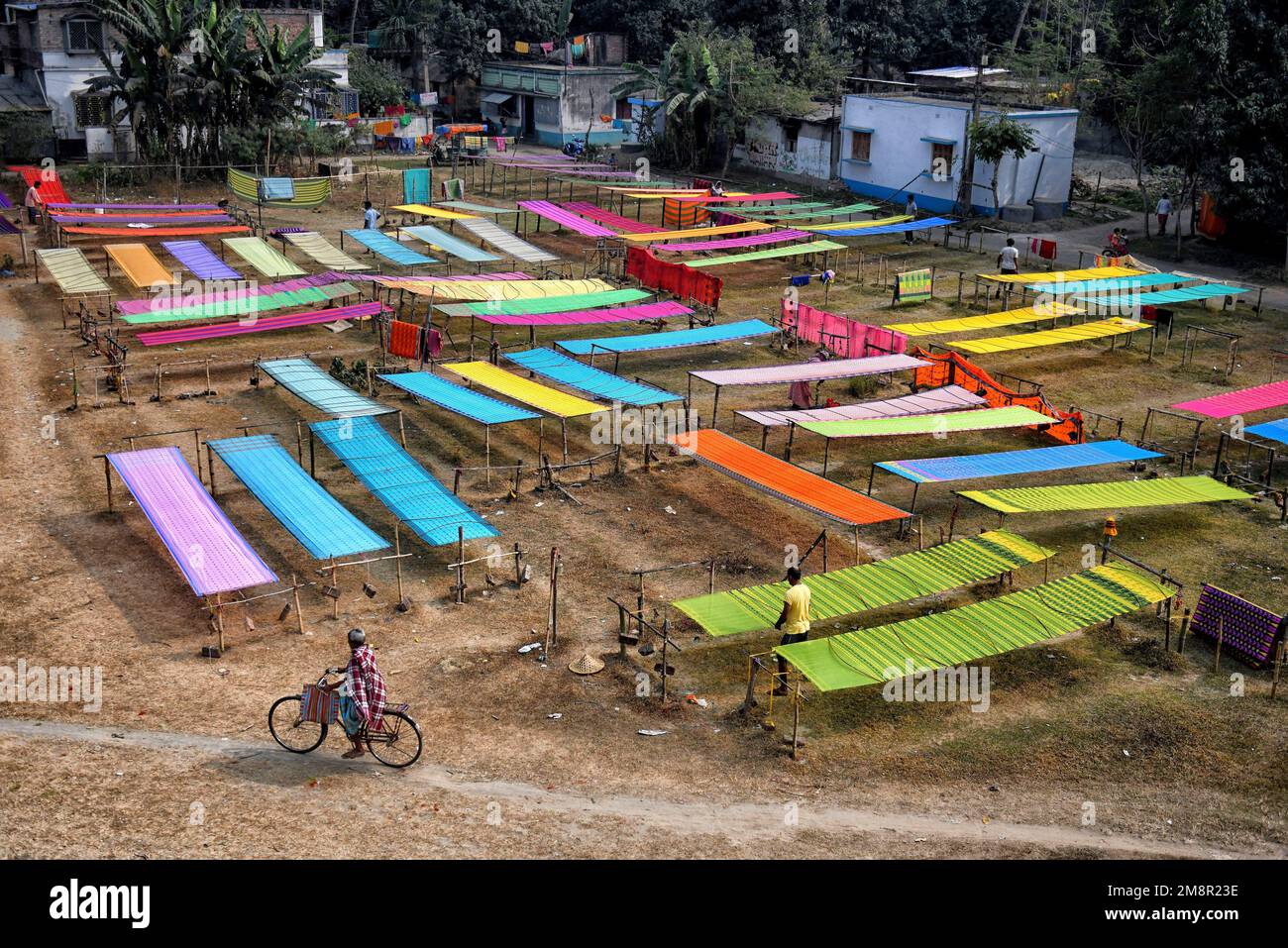 A view of colourful Indian sarees drying under sun. The traditional ...