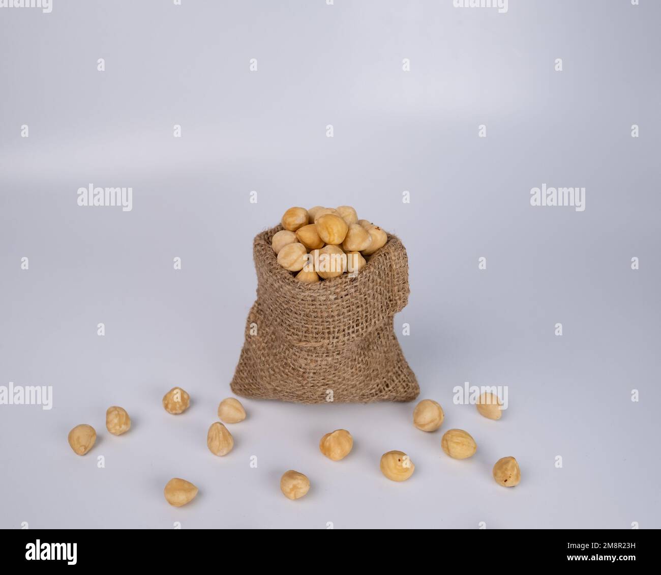 Nuts In A Fabric Sack On A White Background Stock Photo - Alamy