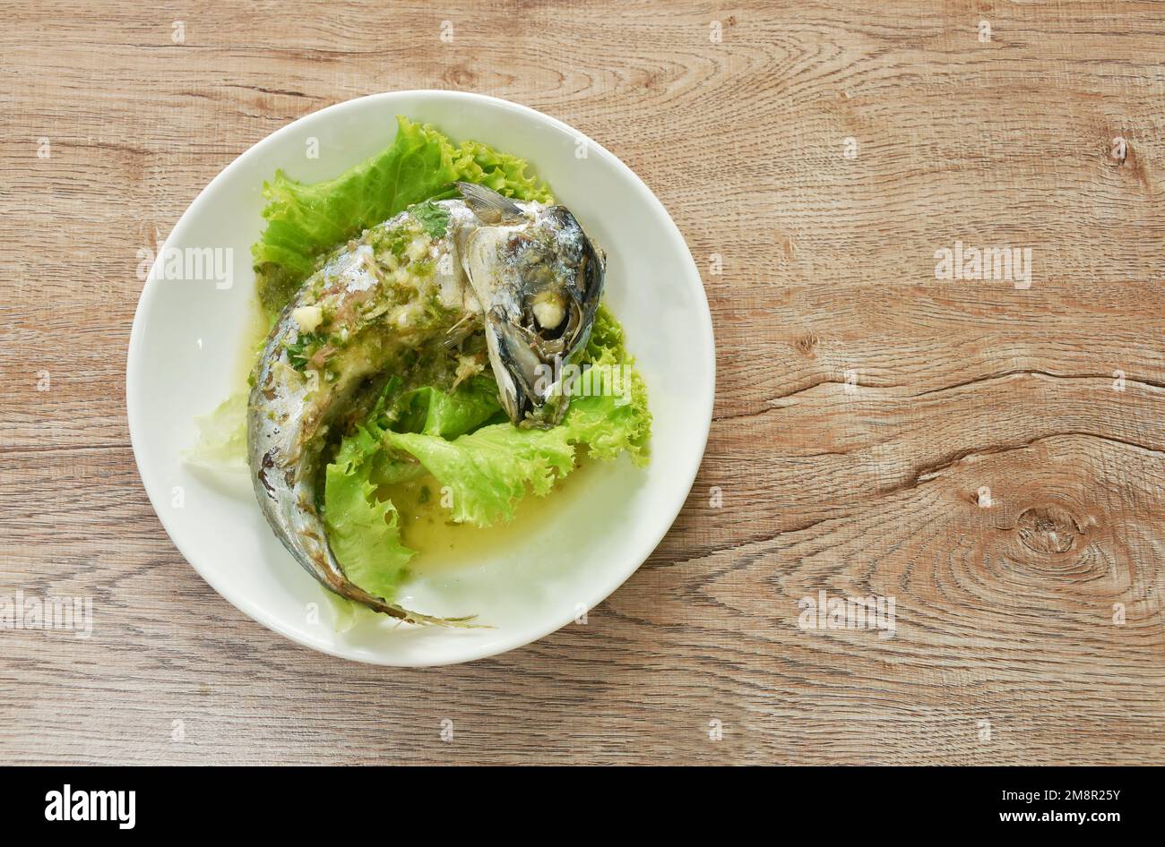 steamed mackerel fish dressing lemon sweet and sour chili sauce on ...