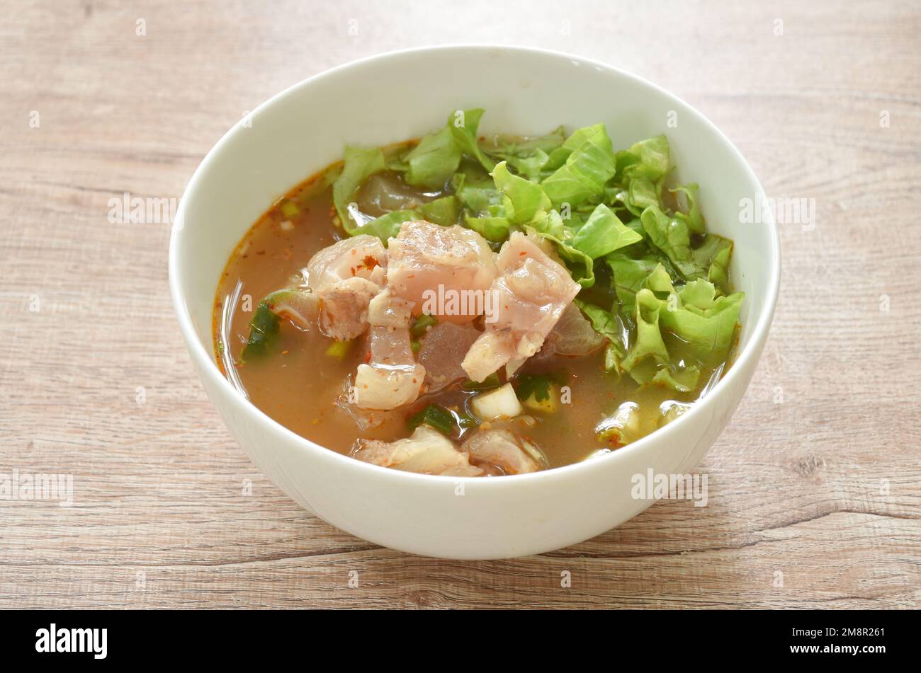 boiled slice braised beef tendon in spicy and sour tom yum soup on bowl ...