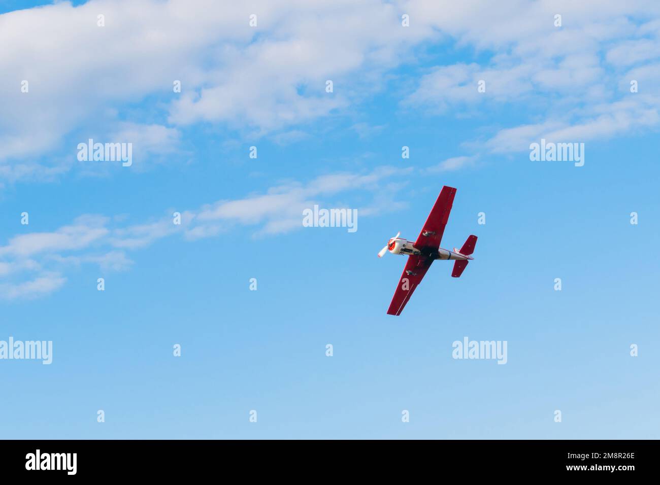 Light aircraft flying in blue sky and doing stunts Stock Photo - Alamy
