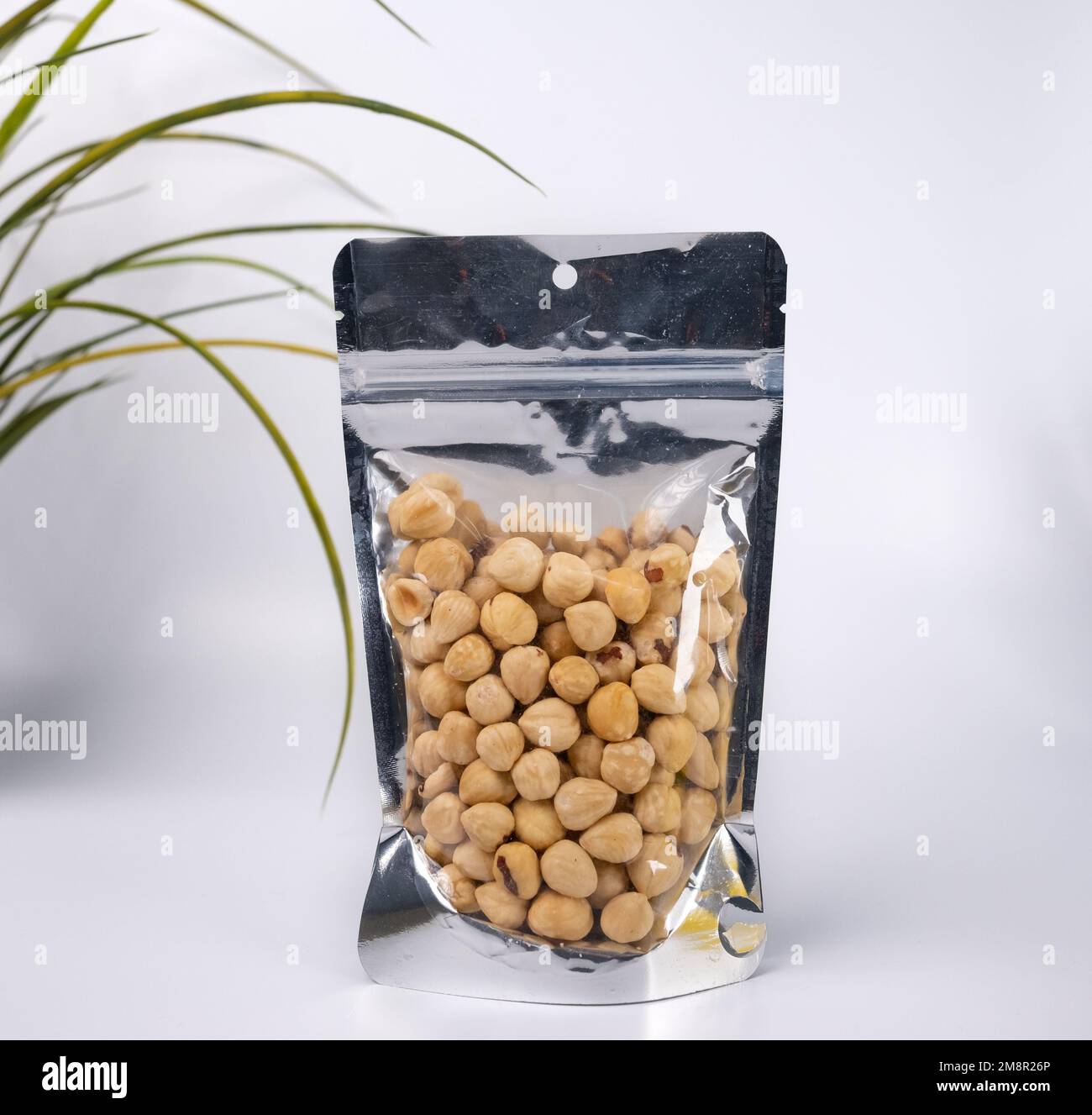 Peeled hazelnuts in doypack or transparent packaging. Nuts isolated in ...