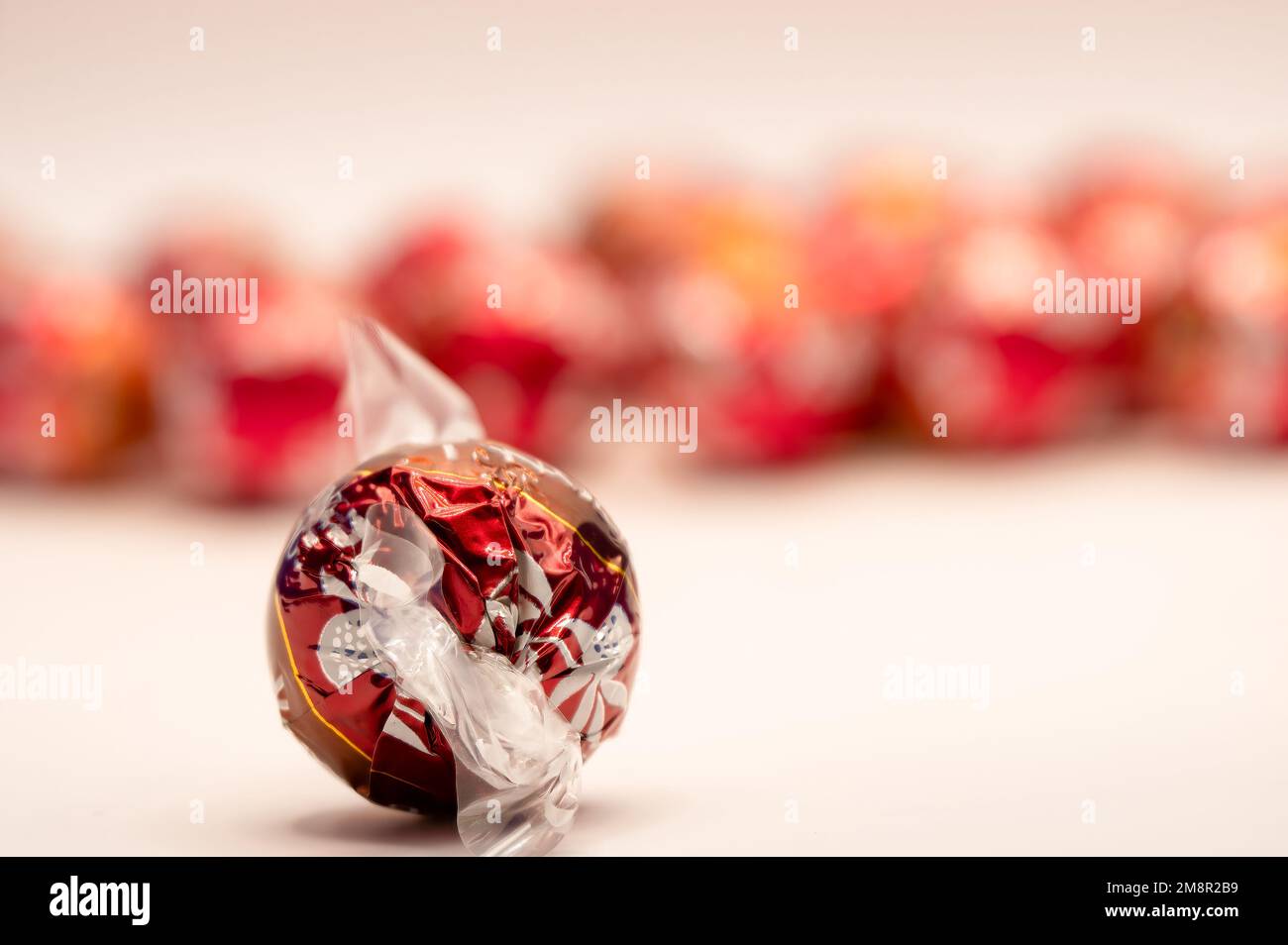 close-up of a red foil wrapped christmas chocolate ball sweet Stock ...