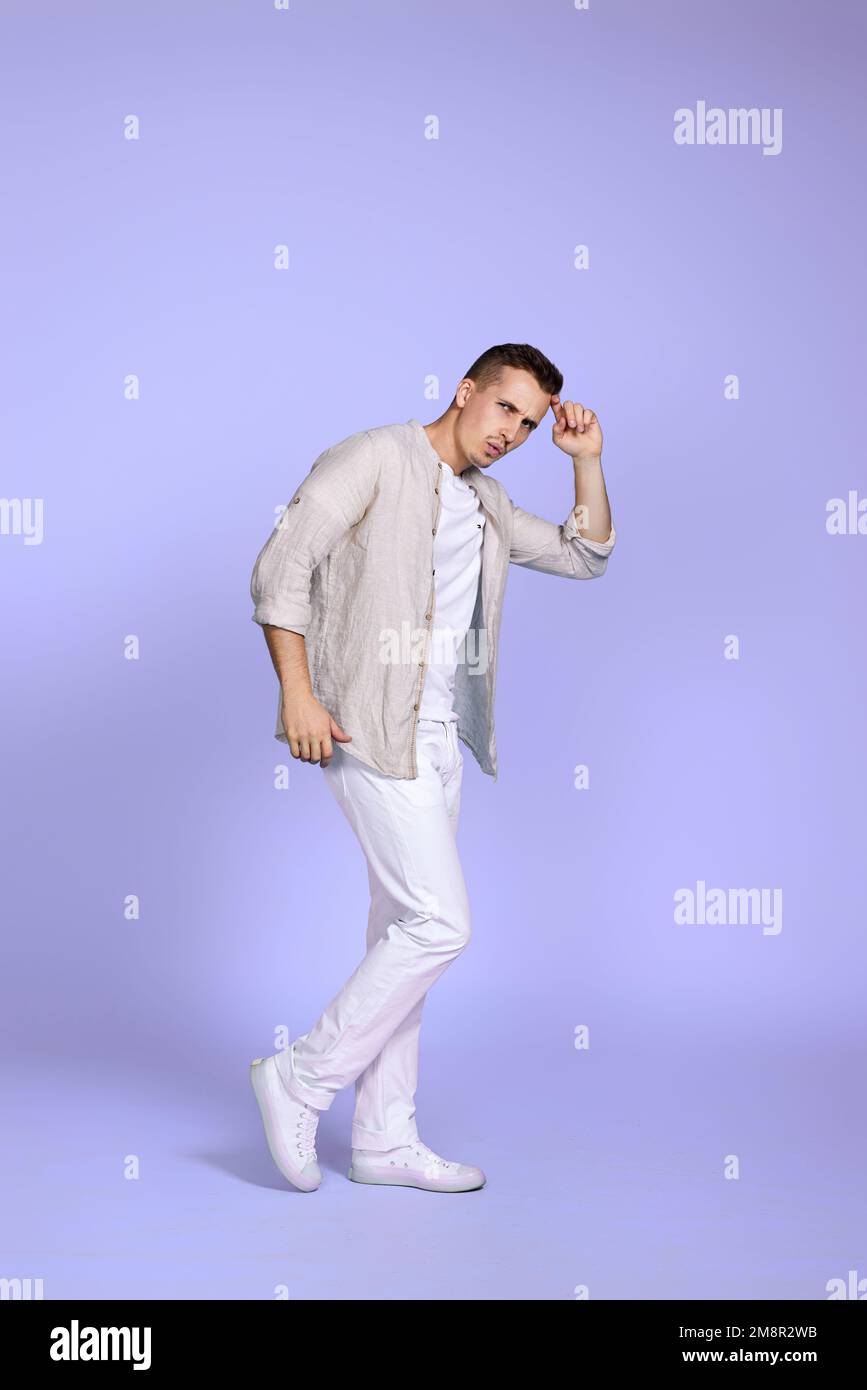 happy man dancing on pastel violet background Stock Photo - Alamy