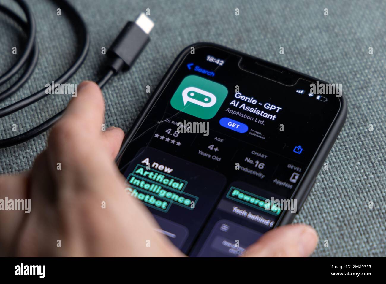 Woman's hand holding an iPhone with appstore and ChatGPT and Chat bot ...