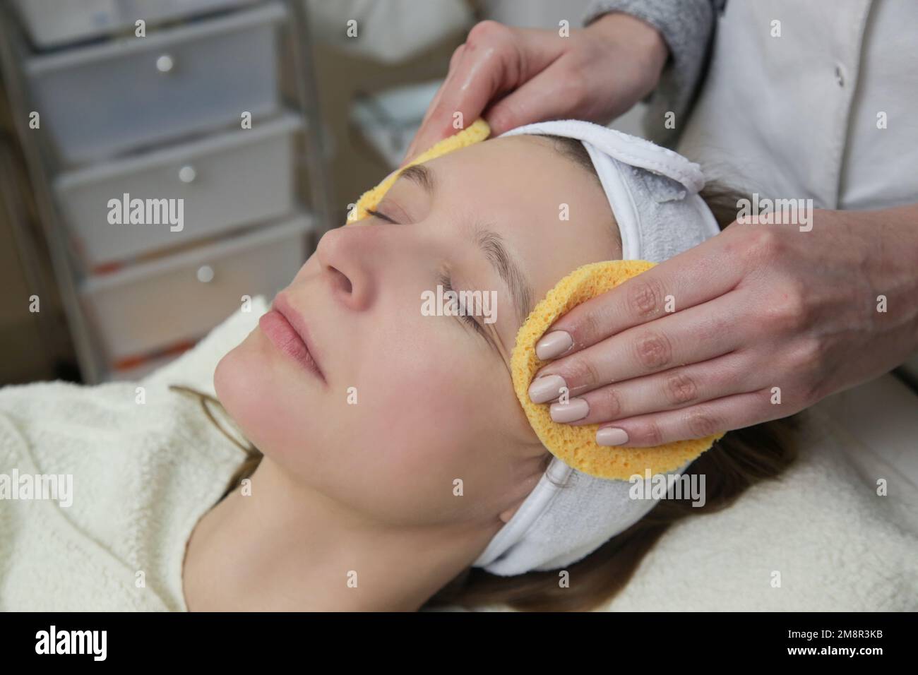 Dermatologist preparing woman's face skin for treatment. Process of ...