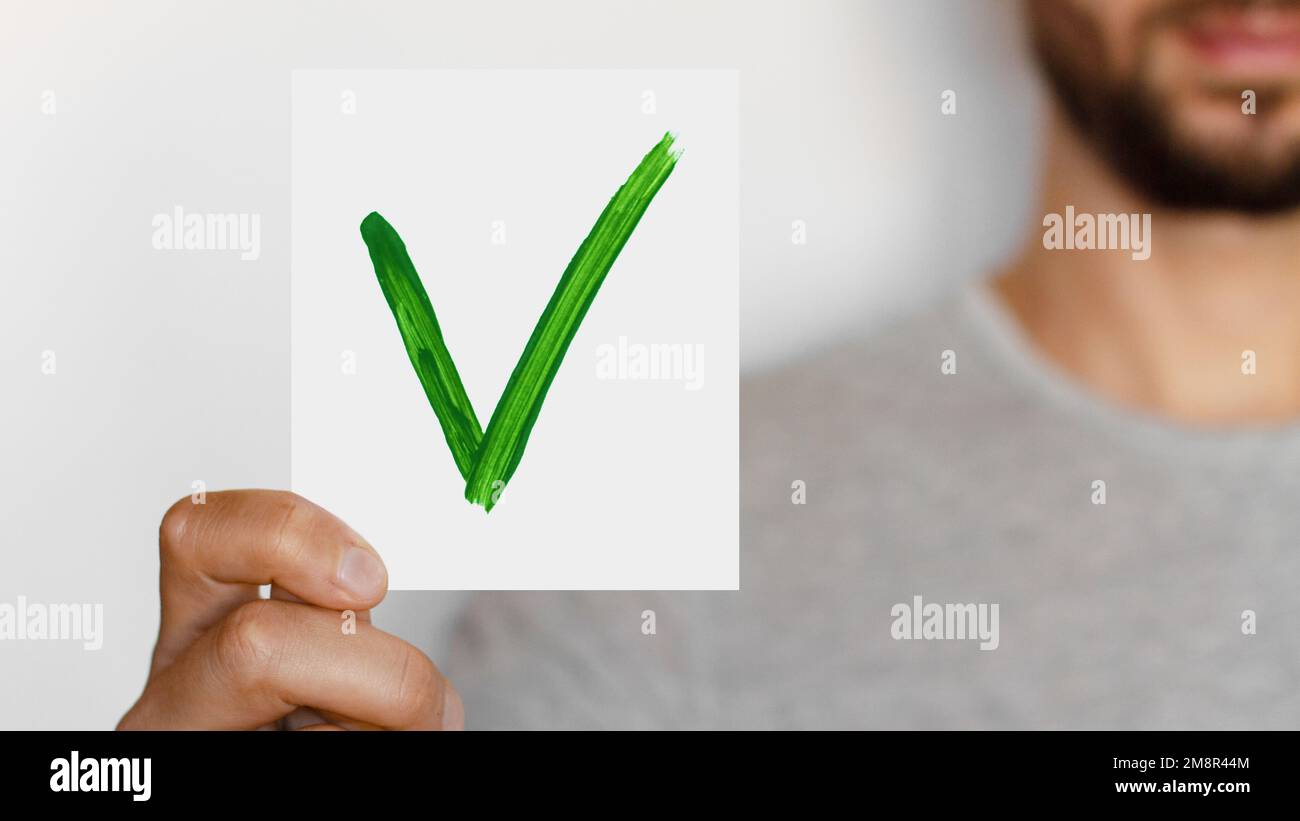 Man holding an approval sign. Green checkmark sign. OK. Okay. OK. The ...