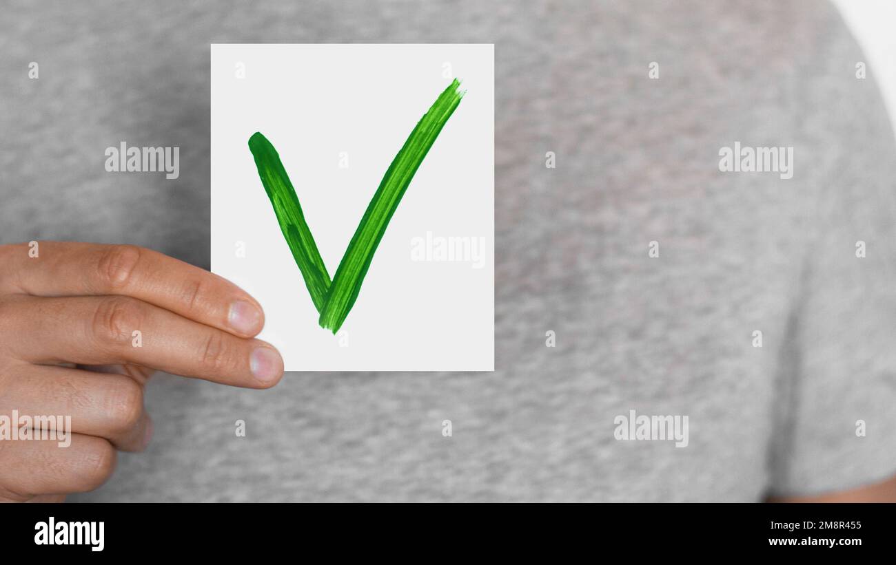 Man holding an approval sign. Green checkmark sign. OK. Okay. OK. The ...