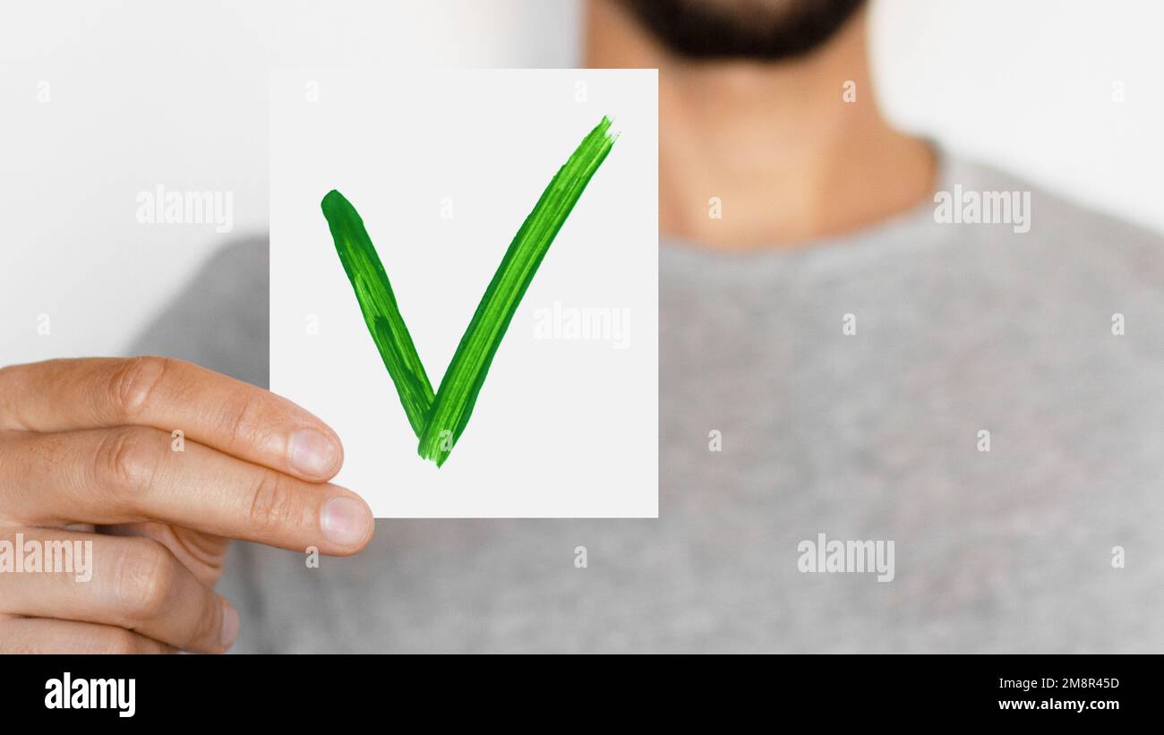 Man holding an approval sign. Green checkmark sign. OK. Okay. OK. The ...