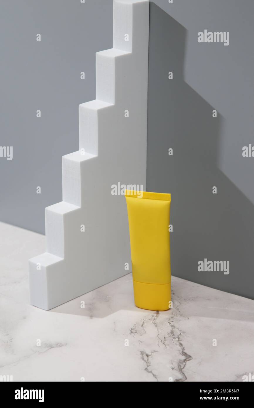 Blank cosmetics yellow tube. Beauty cosmetic package mockup Stock Photo ...