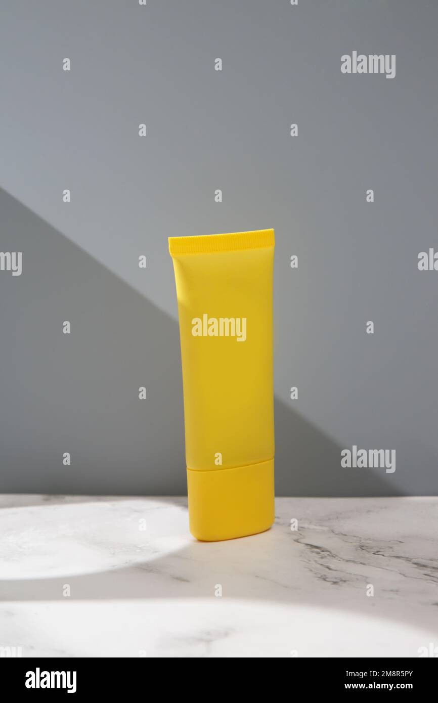 Blank cosmetics yellow tube. Beauty cosmetic package mockup Stock Photo ...
