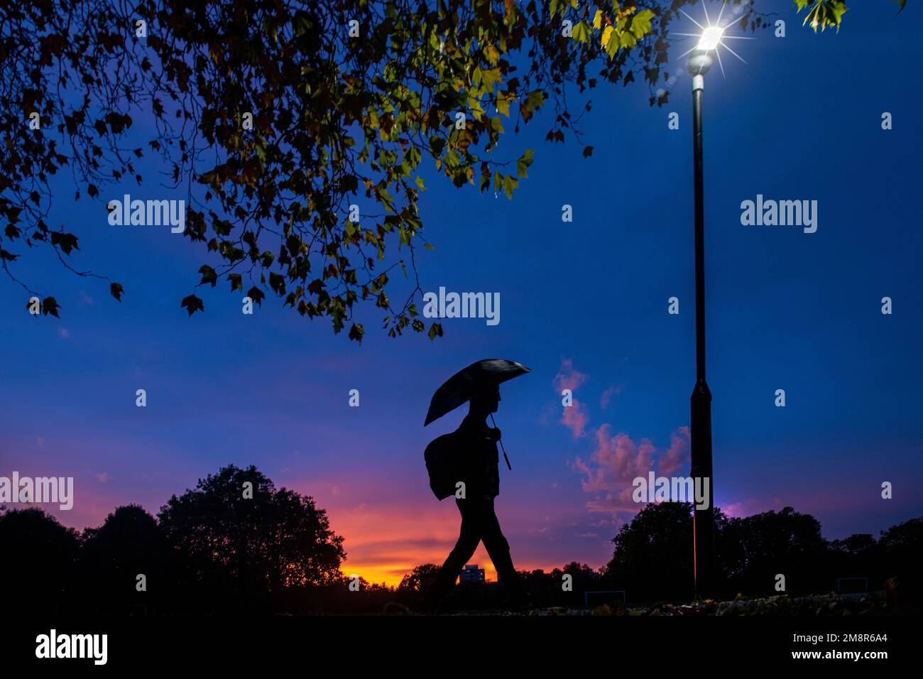 London: walking in the rain with an umbrella on an autumnal, damp day ...