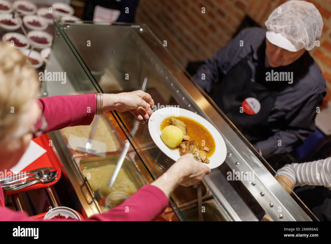 Nuremberg, Germany. 15th Jan, 2023. A woman accepts her lunch at the ...