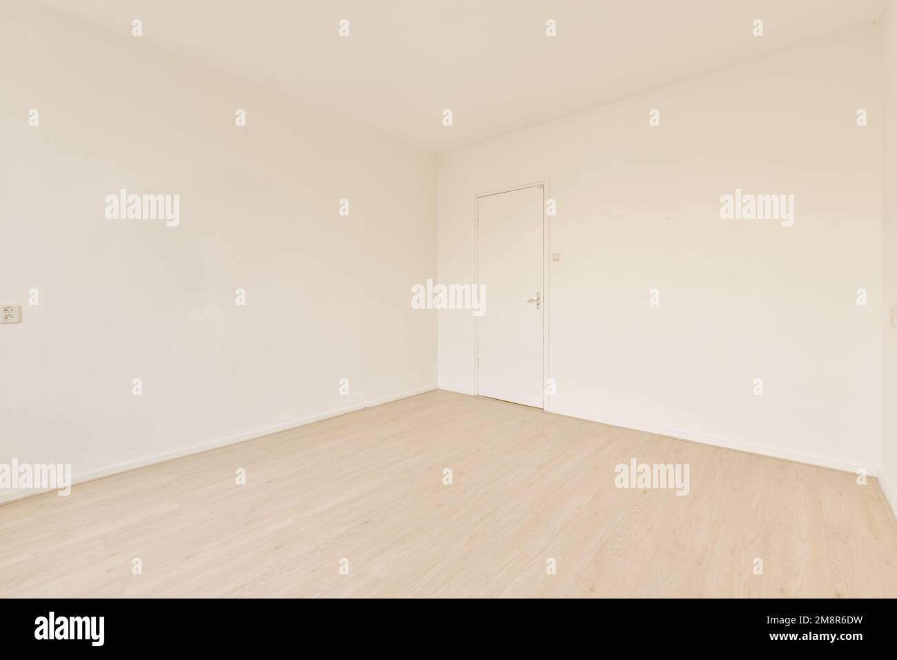 an empty room with white walls and wood flooring on the right hand side ...