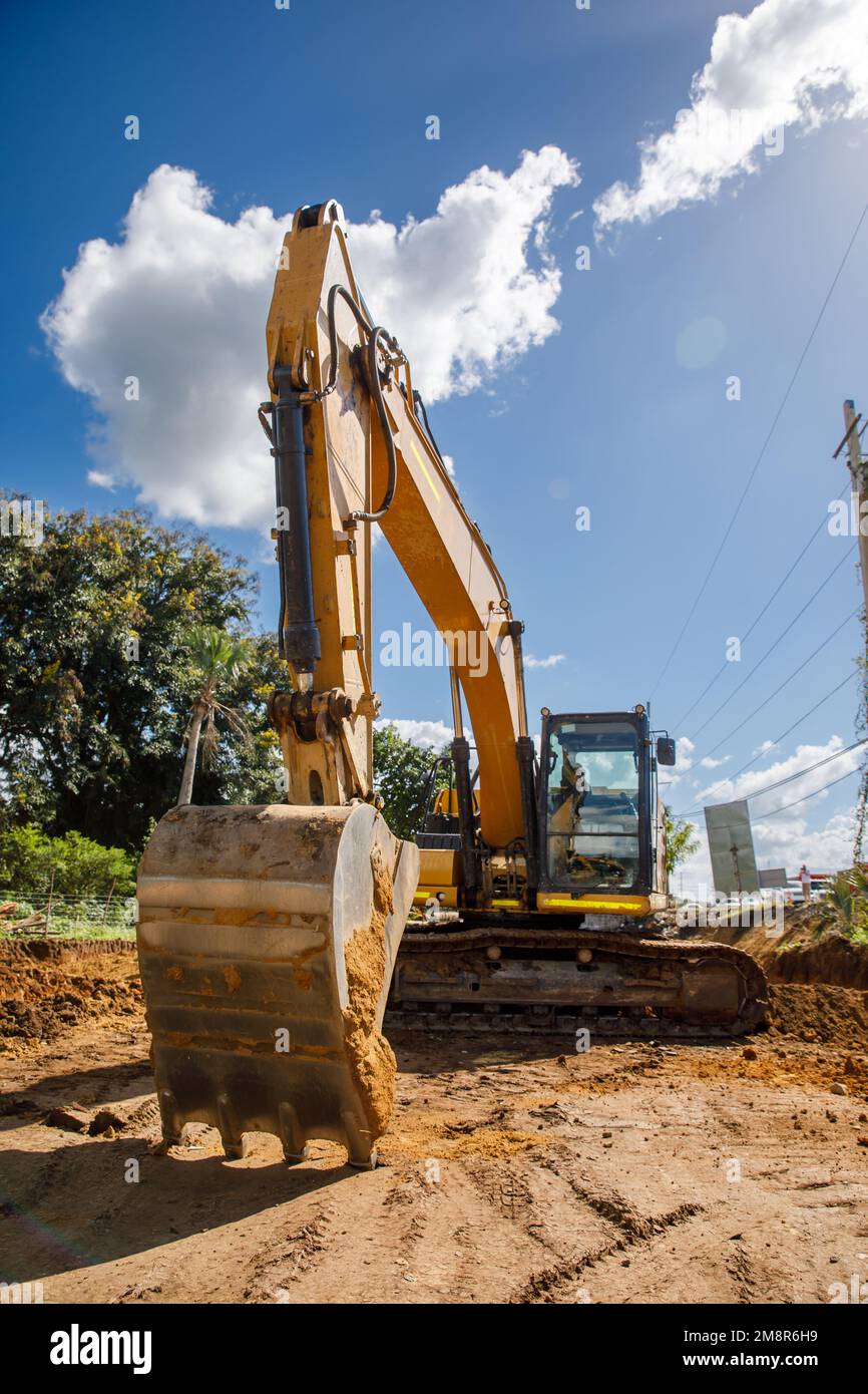 A large construction excavator of yellow color on the construction site ...