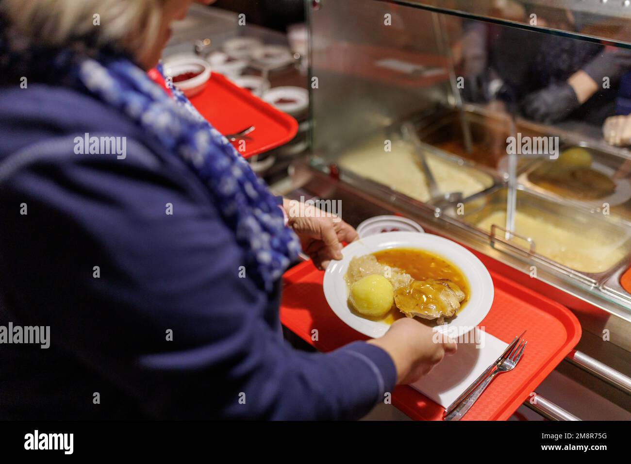 Nuremberg, Germany. 15th Jan, 2023. A woman puts her lunch on a tray at ...