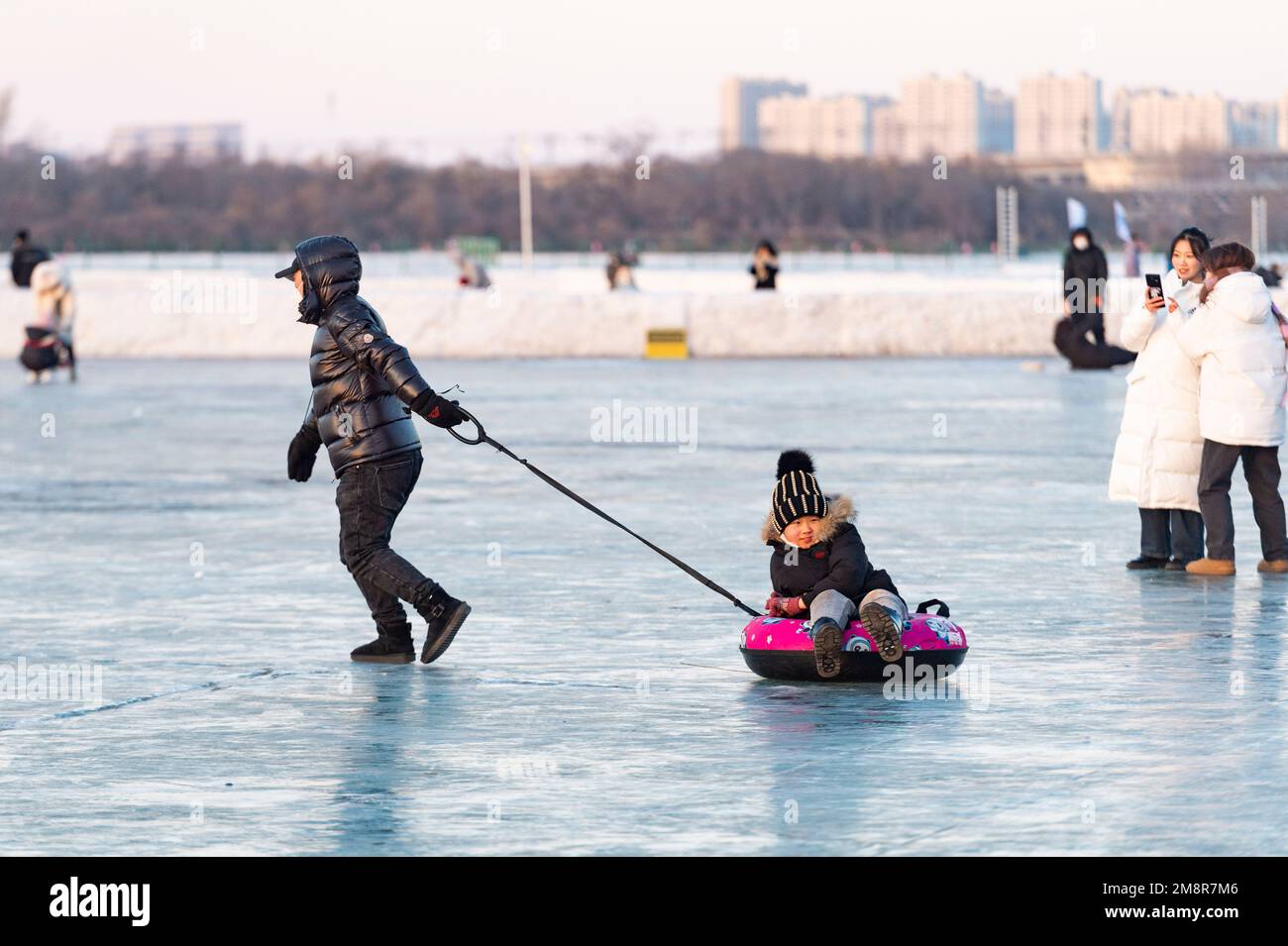 Harbin, China's Heilongjiang Province. 14th Jan, 2023. People have fun ...
