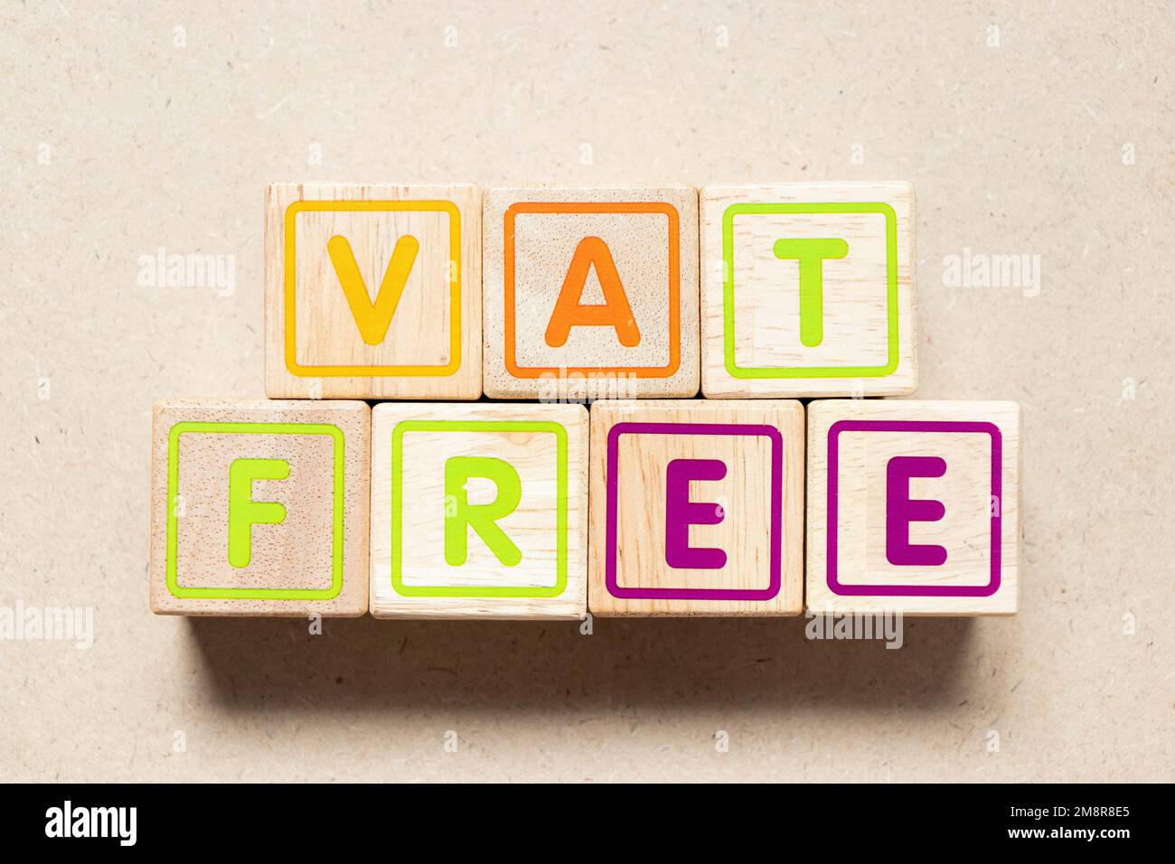 Color letter block in word VAT free on wood background Stock Photo - Alamy