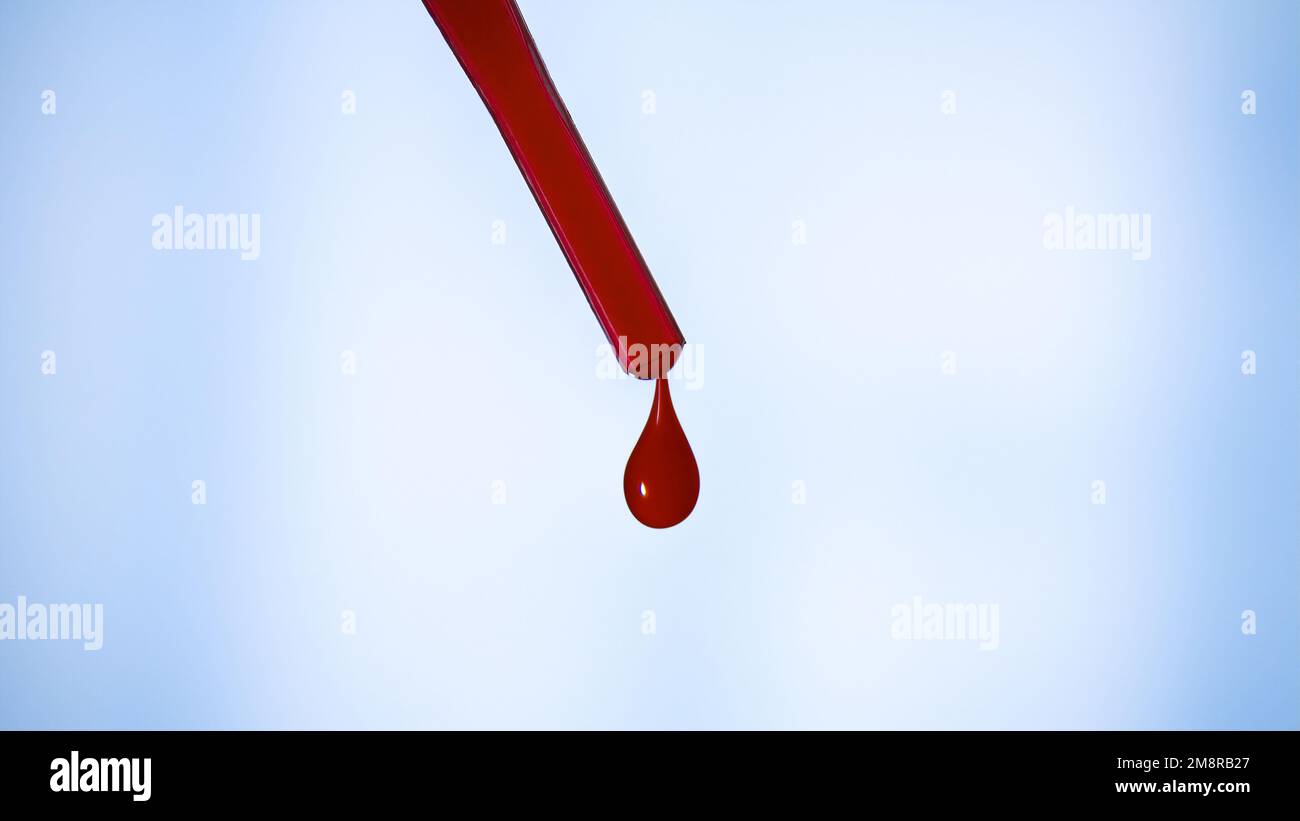 A drop of blood. Pipette. Dripping red liquid. A drop of red. Tests ...