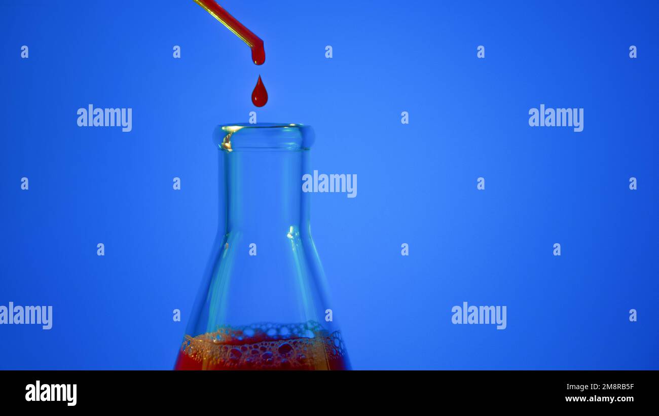 A drop of blood. Pipette. On a blue background. Medical flask with red ...