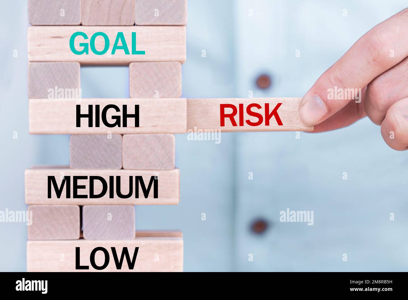 Hand holding chooses wooden block cubes with risk word. Risk management ...