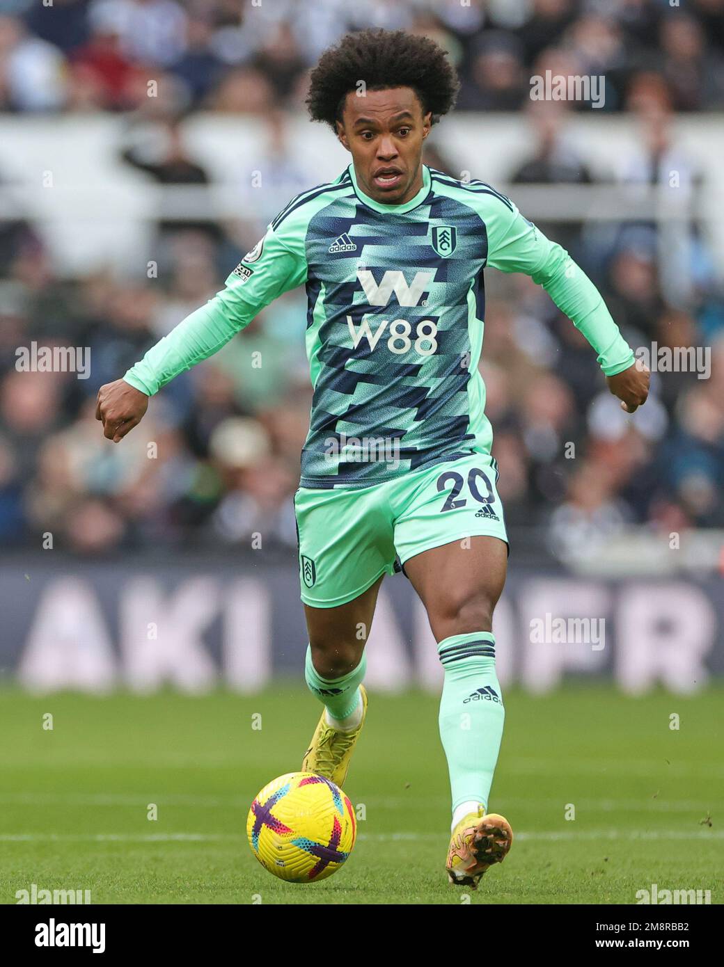 Willian #20 of Fulham runs with the ball during the Premier League ...